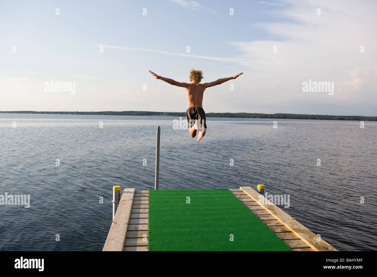 Child jumping off a pier hi-res stock photography and images - Alamy