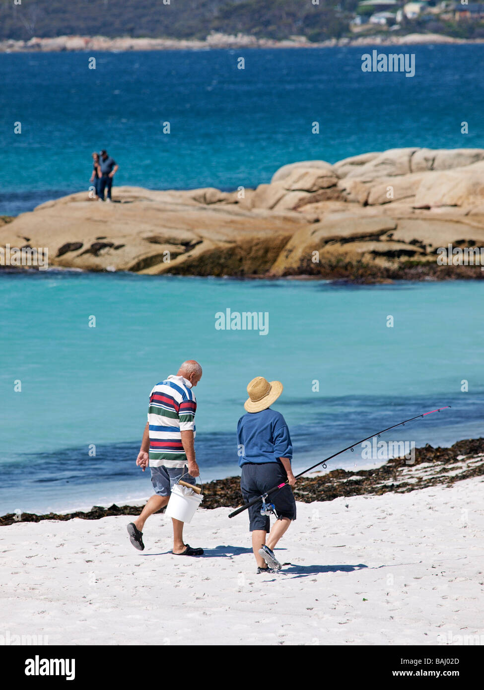 COUPLE WITH FISHING ROD ON BEACH AT BINALONG BAY TASMAINIA AUSTRALIA ...