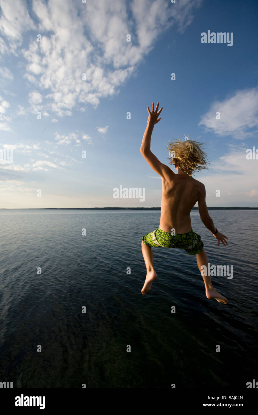 Child jumping off a pier hi-res stock photography and images - Alamy