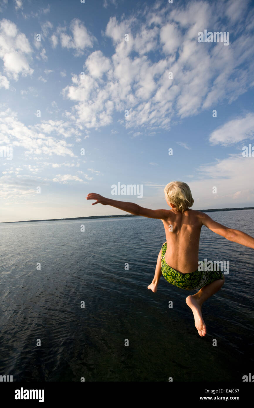 Child jumping off a pier hi-res stock photography and images - Alamy