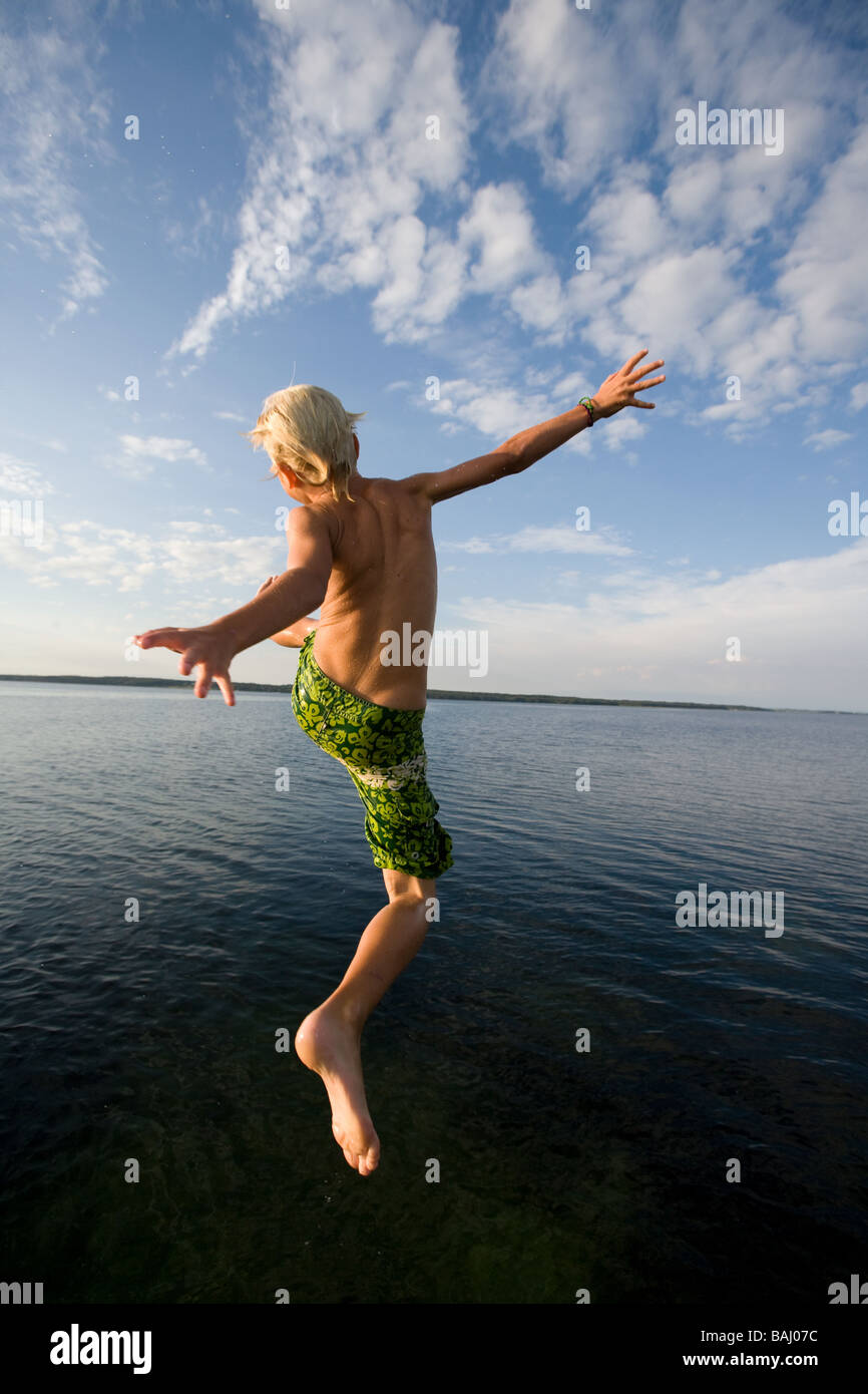 Child jumping off a pier hi-res stock photography and images - Alamy