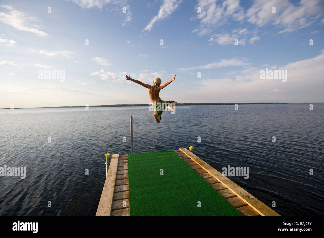 Child jumping off a pier hi-res stock photography and images - Alamy