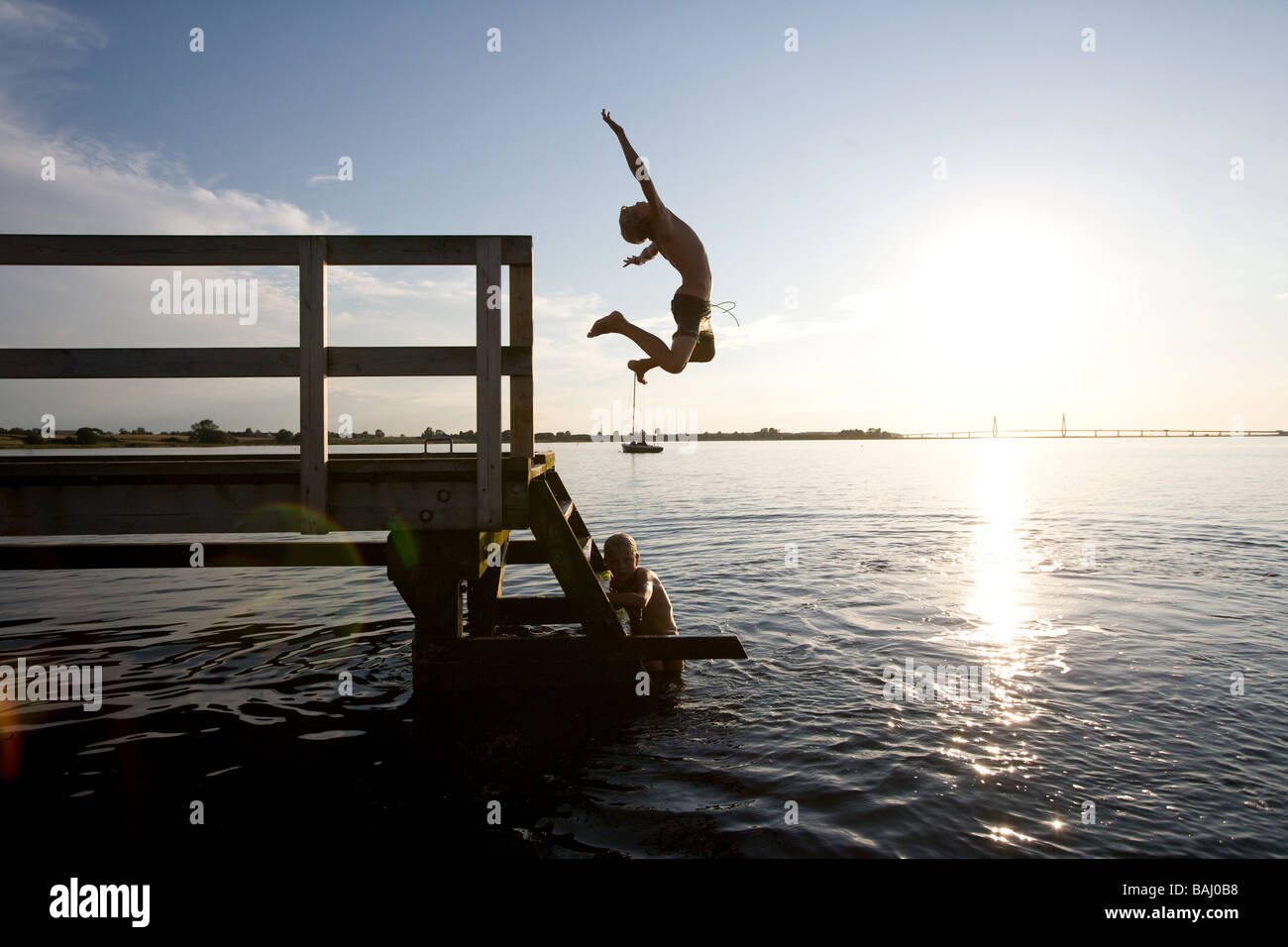 Child jumping off a pier hi-res stock photography and images - Alamy