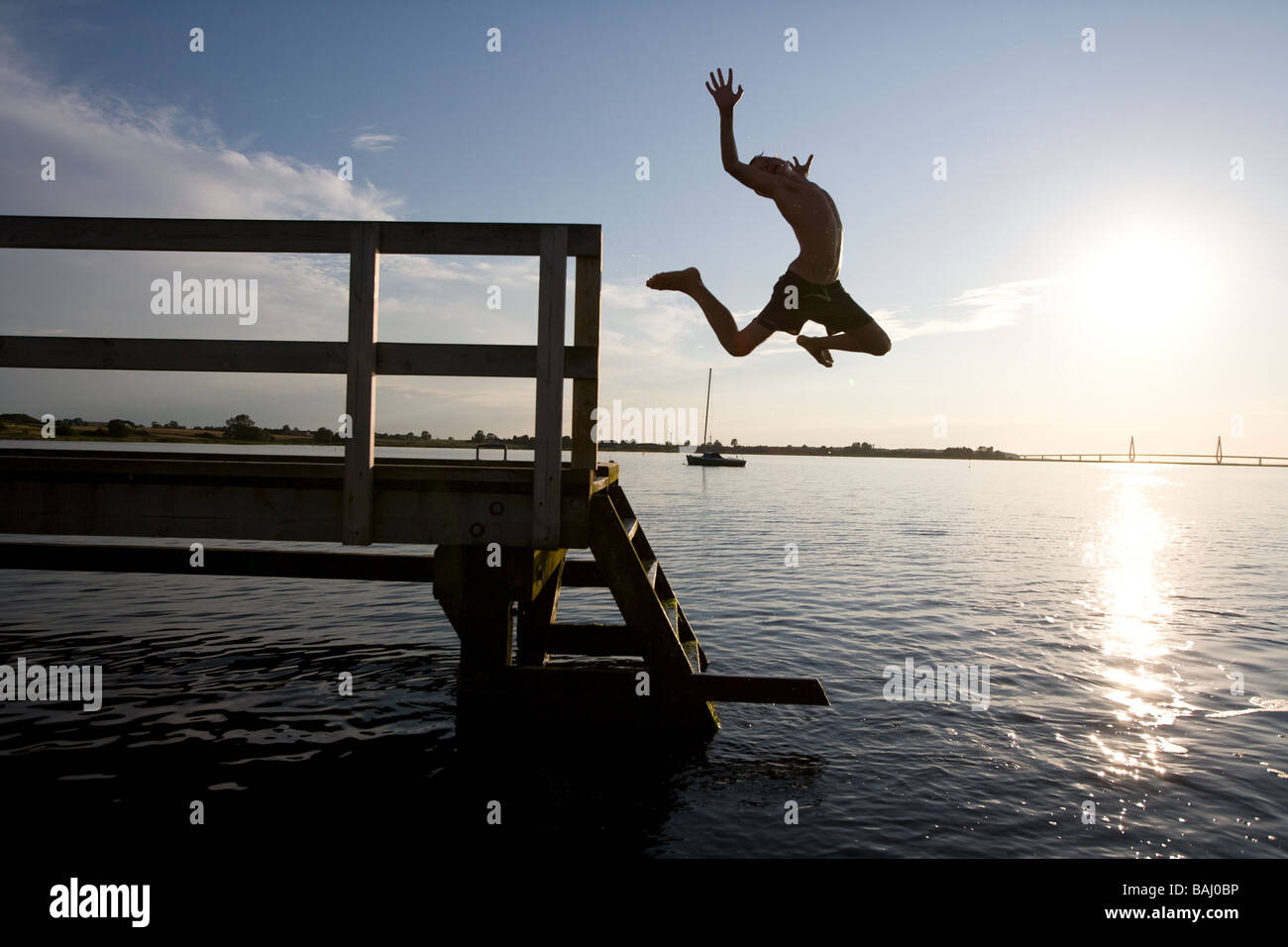 Child jumping off a pier hi-res stock photography and images - Alamy