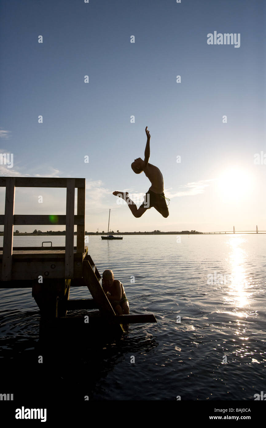 Boy diving off pier in hi-res stock photography and images - Alamy