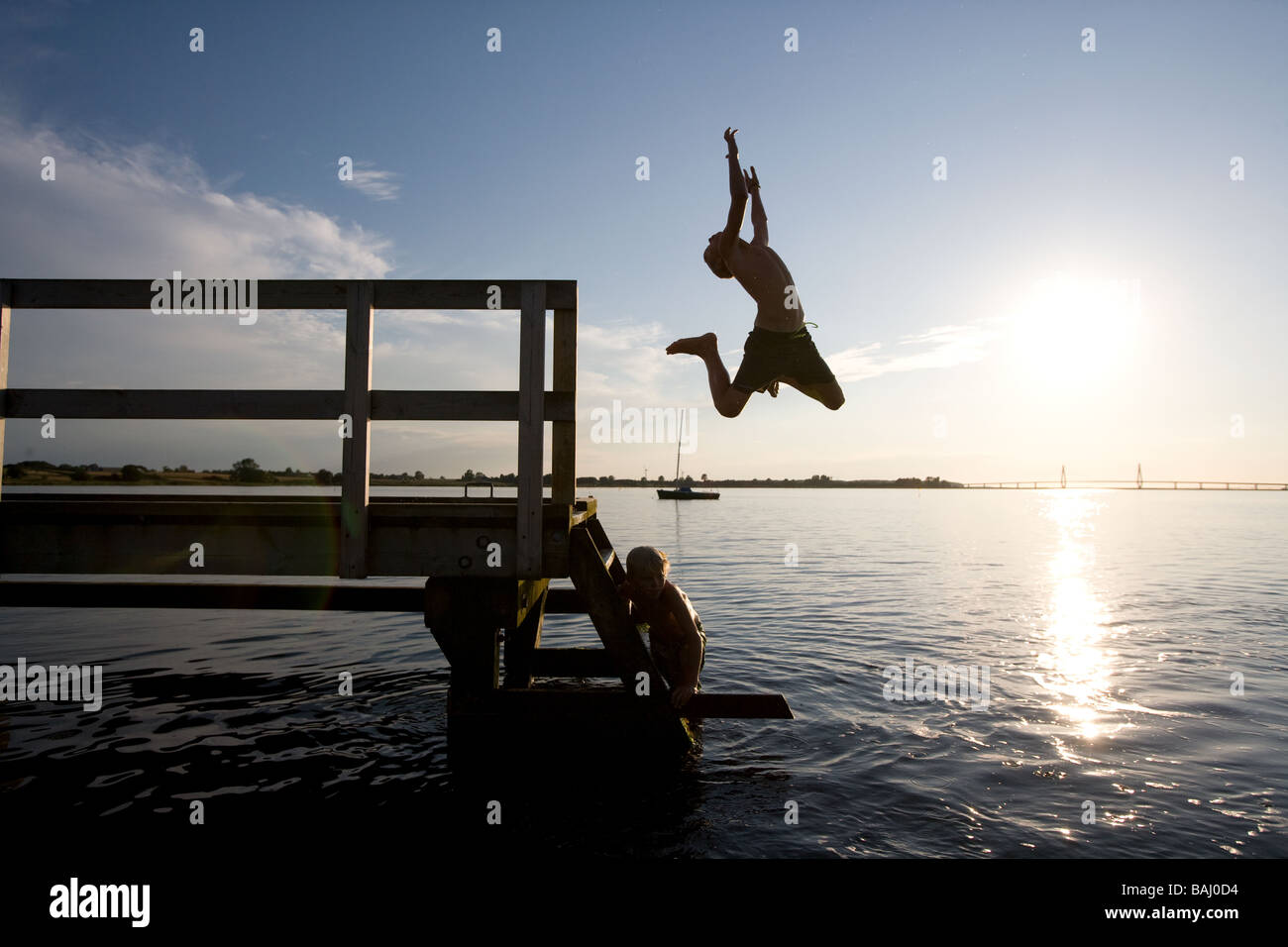 Boy diving off pier in hi-res stock photography and images - Alamy
