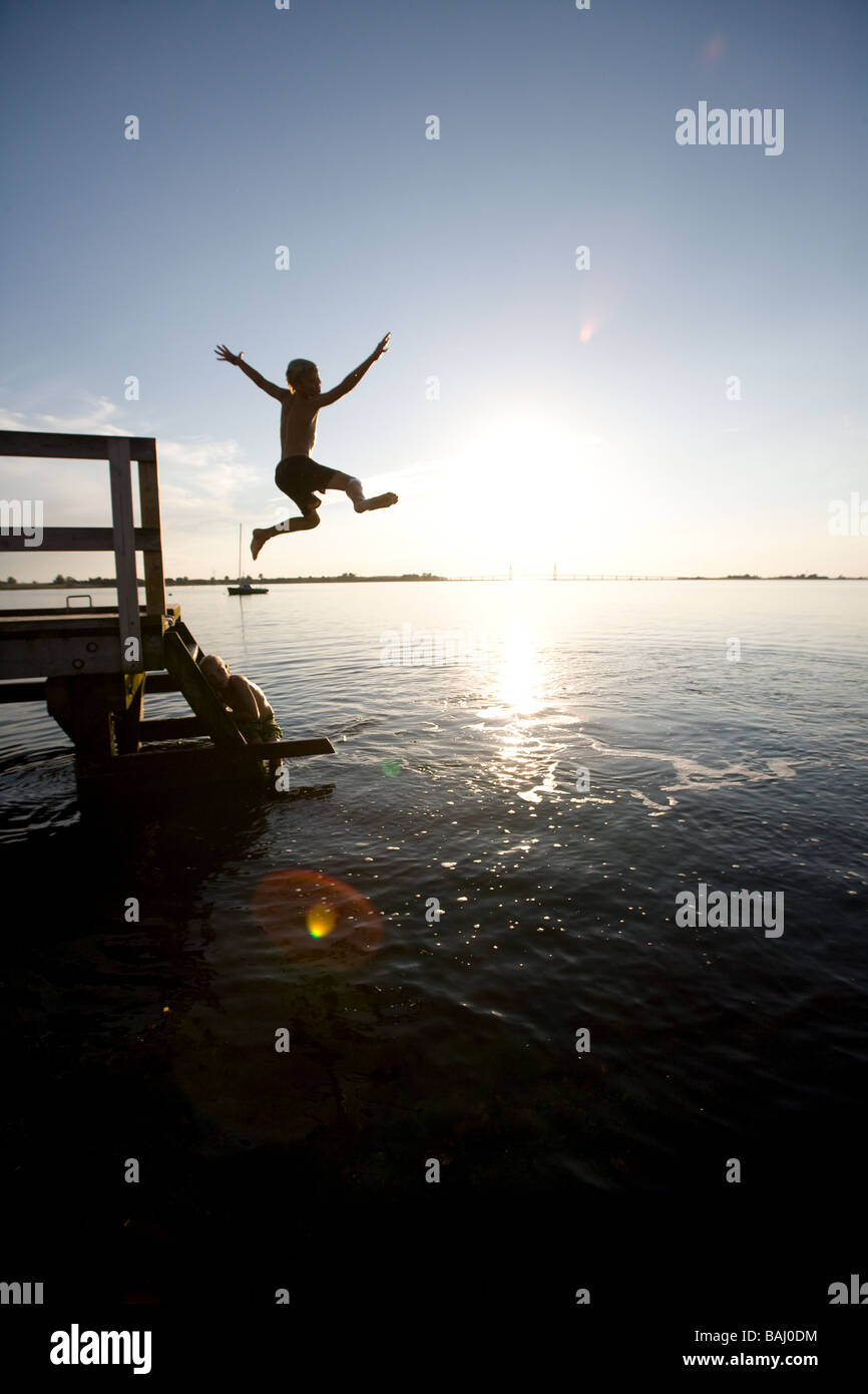 Boy diving off pier in hi-res stock photography and images - Alamy