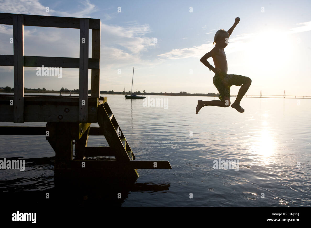 Boy diving off pier in hi-res stock photography and images - Alamy