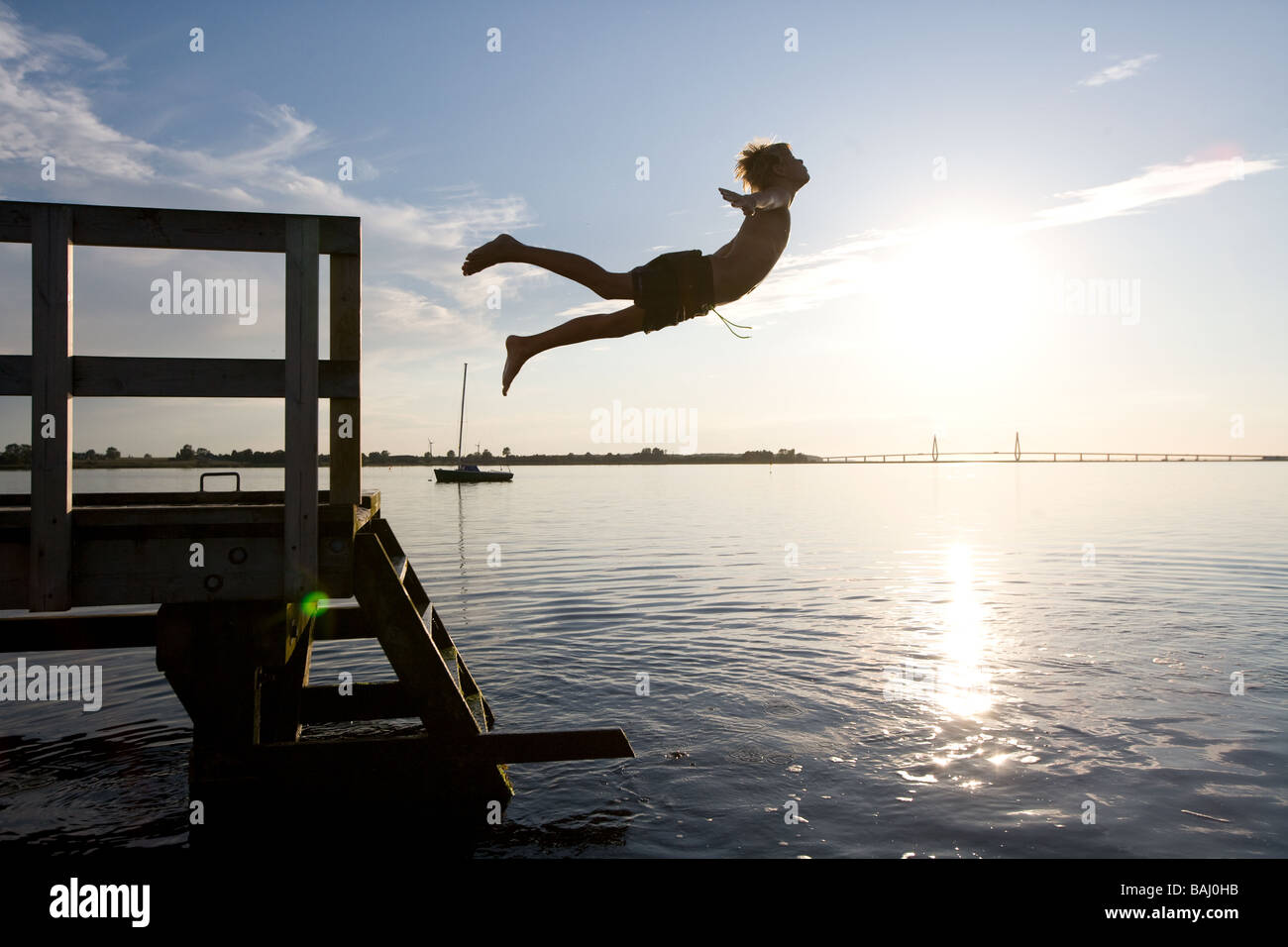 Boy jumping off dock lake hi-res stock photography and images - Alamy