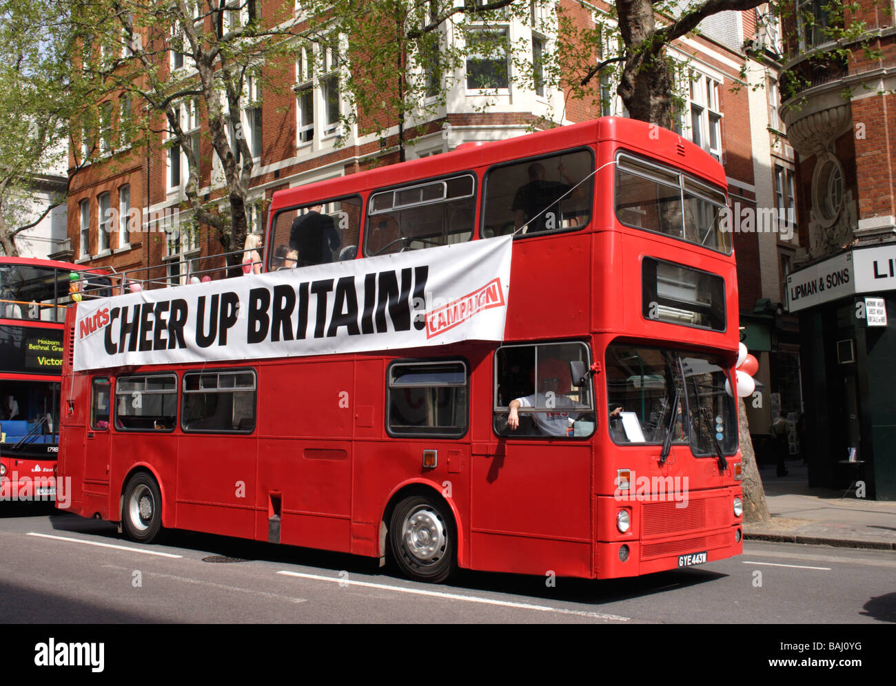 Double decker London bus at Charing Cross Road displaying Cheer Up ...