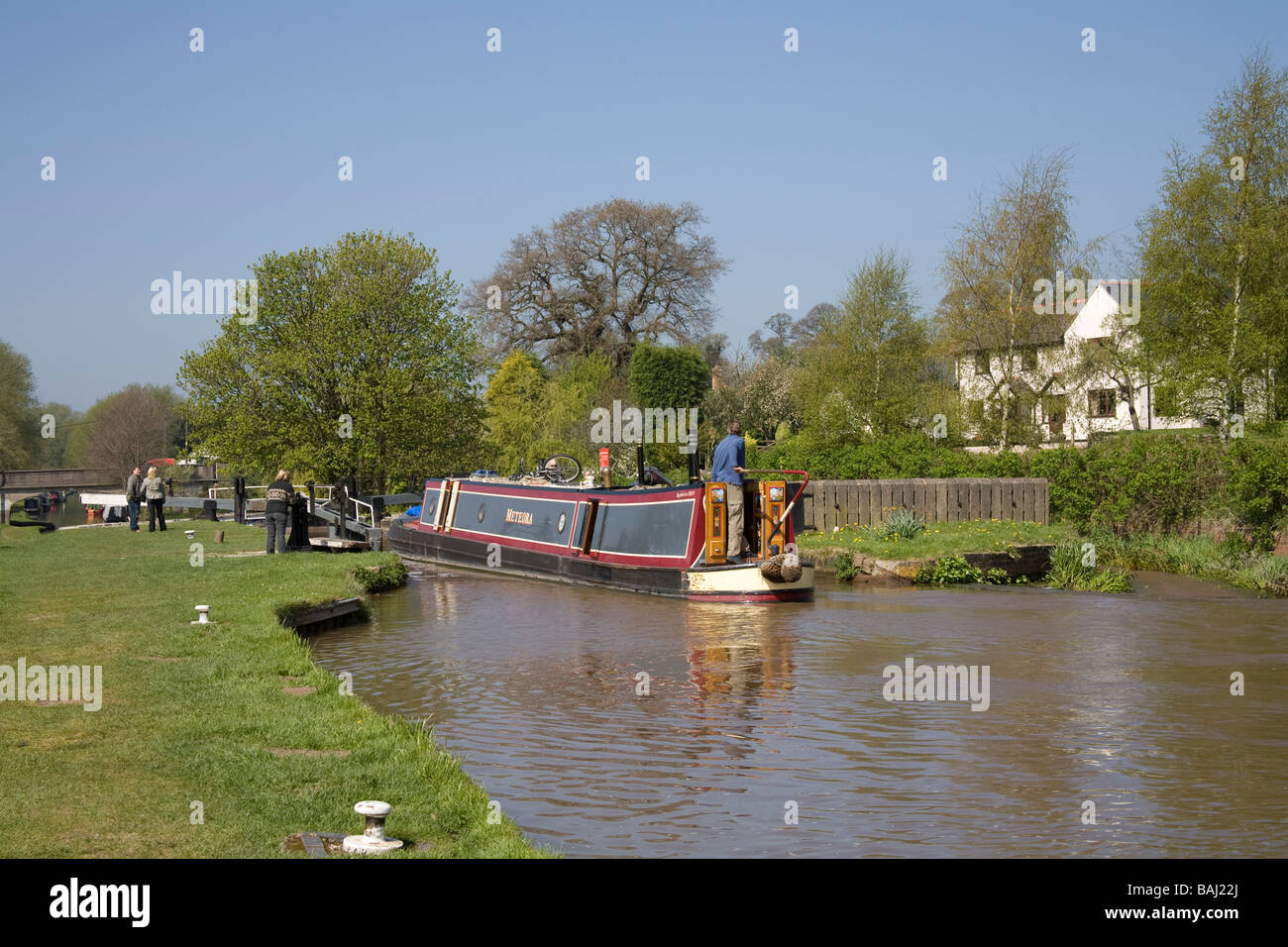 Beeston Cheshire England UK April Man steering his narrowboat into ...