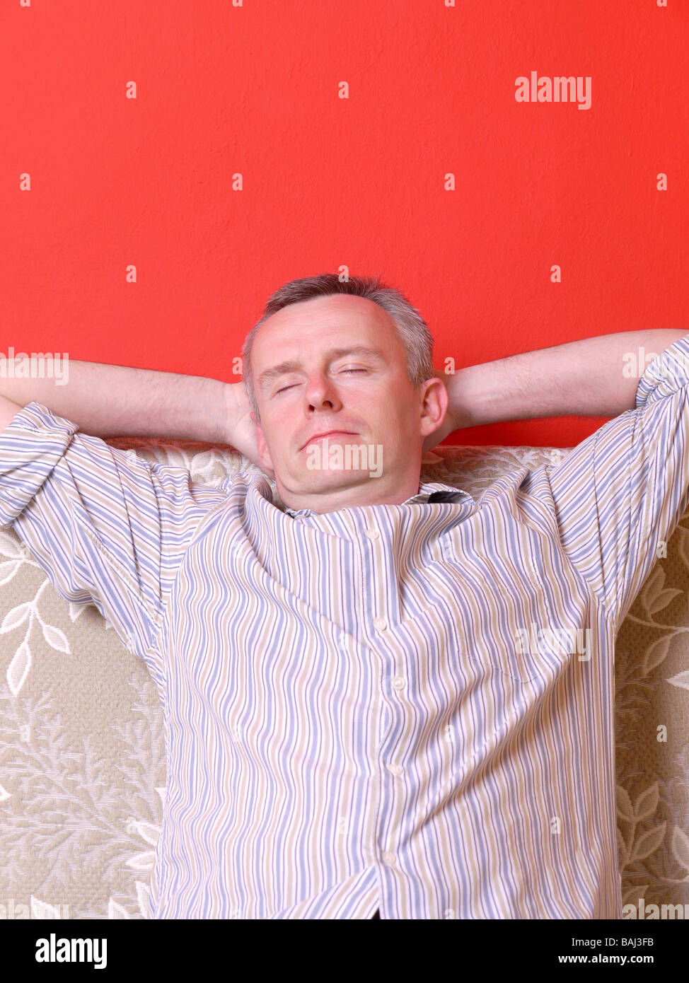 Young man taking a nap on sofa Stock Photo - Alamy