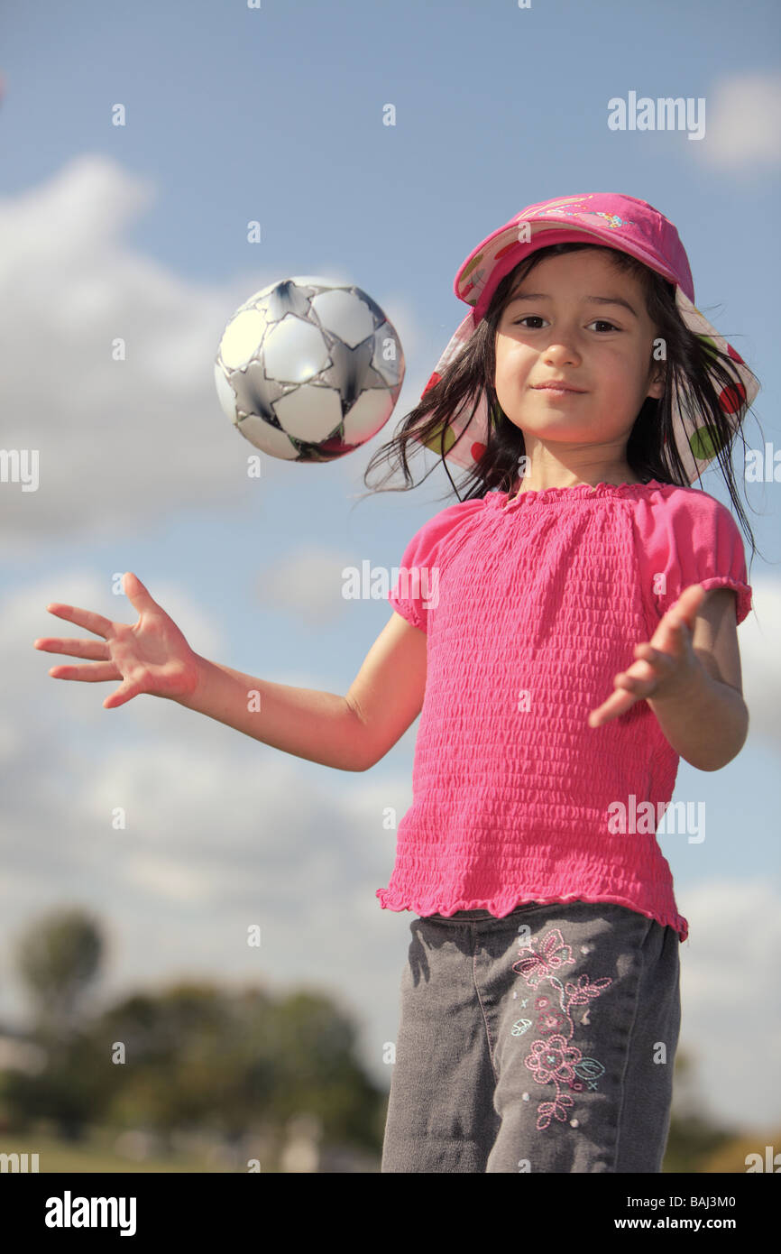 Young girl playing with ball in park Stock Photo - Alamy