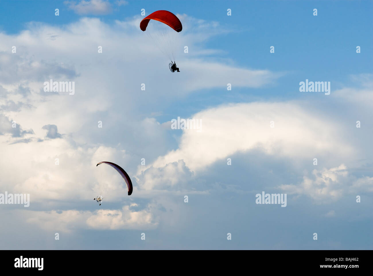 two paraglider pilots in flight against dramatic clouds Stock Photo - Alamy