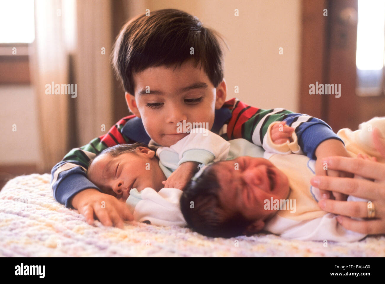 Hispanic boy twin brother sister baby babies sibling hug love cozy care ...