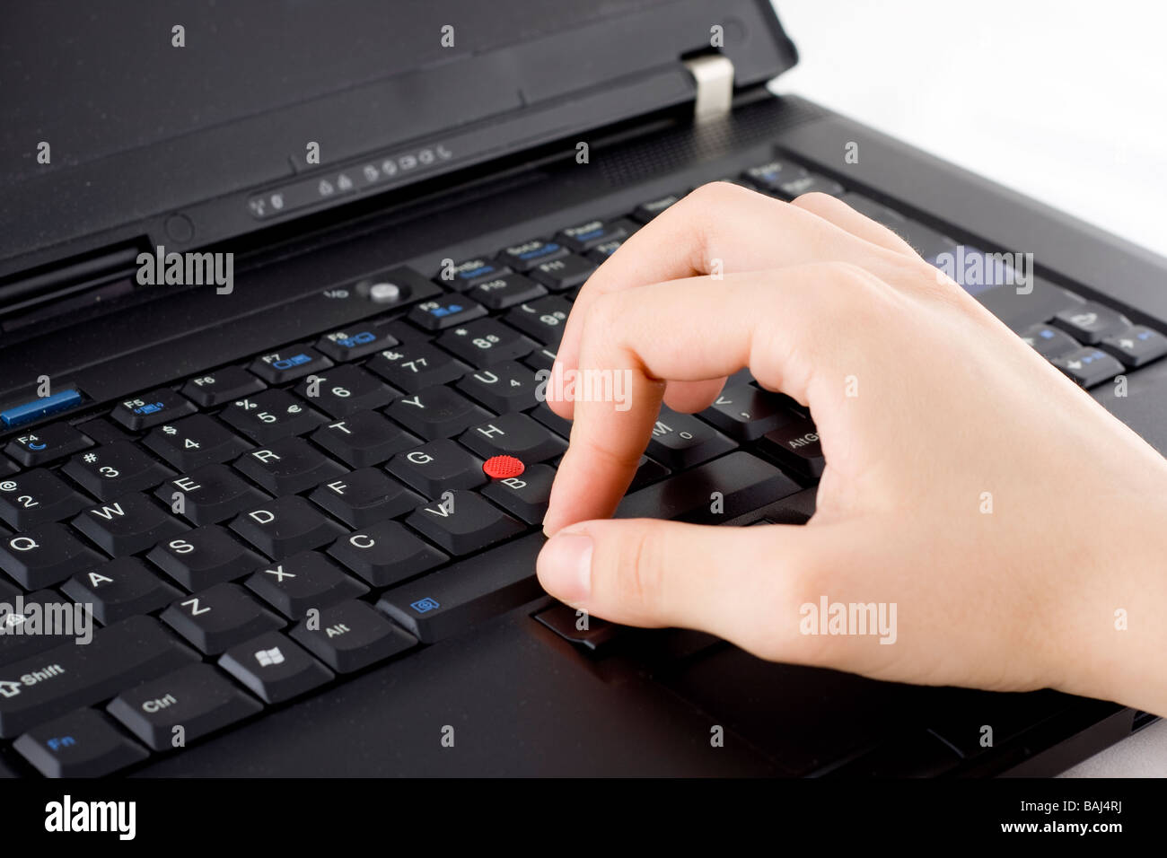 Typing with right hand on a black laptop Stock Photo - Alamy