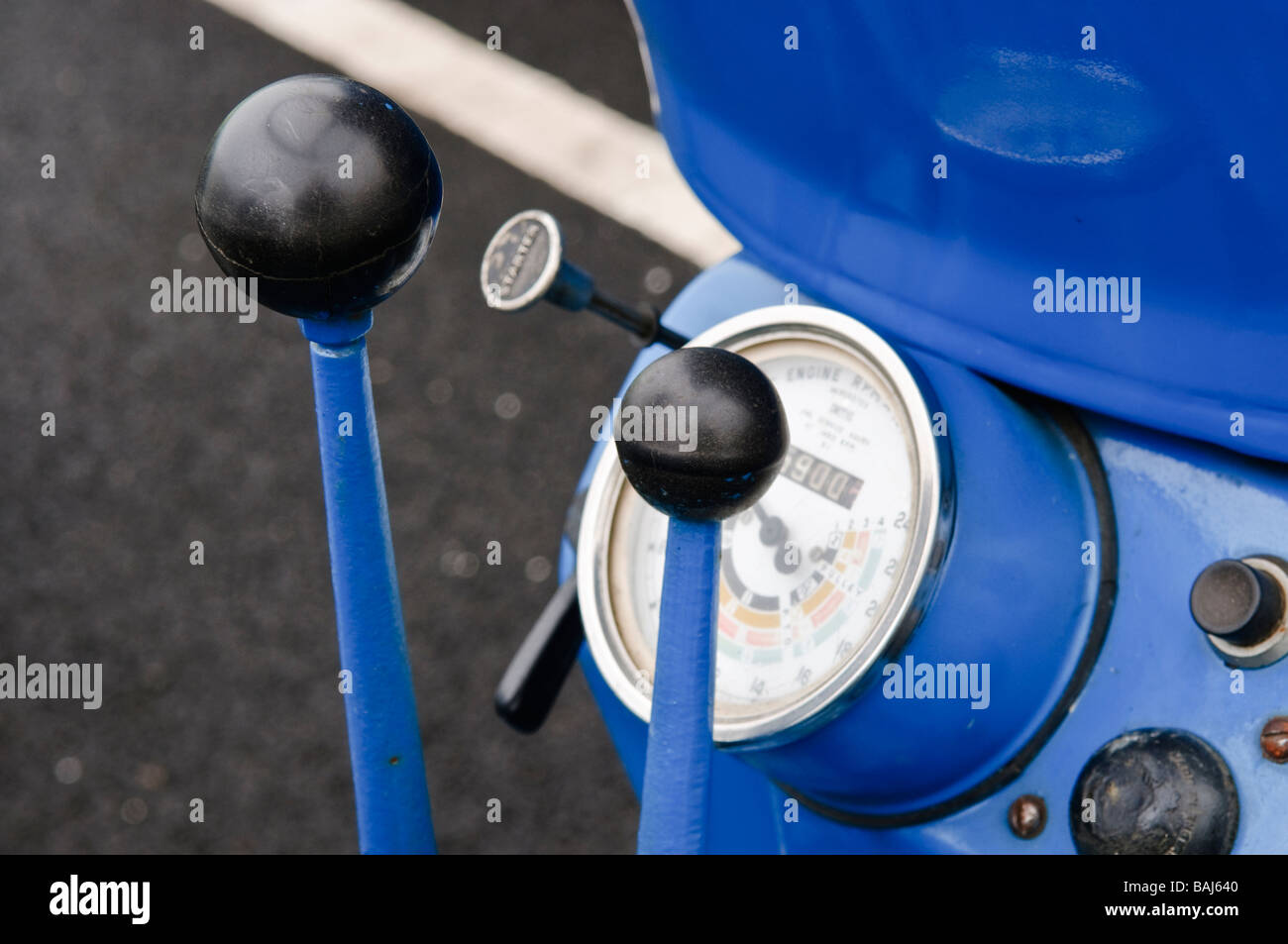 Gear stick, ratio selector and speedometer on a blue vintage farm ...