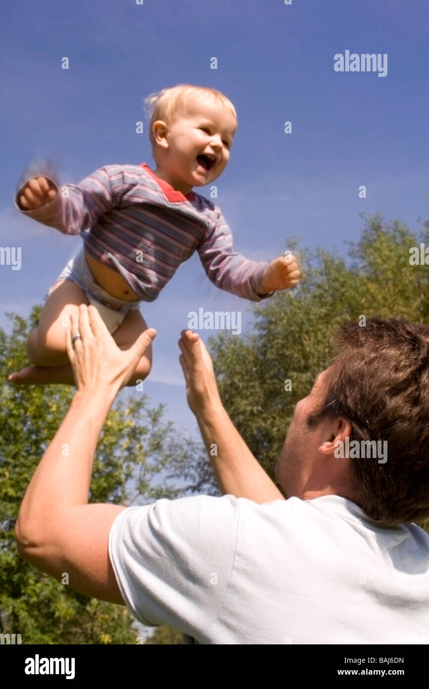 boy thrown in air by father laughing having fun Stock Photo - Alamy