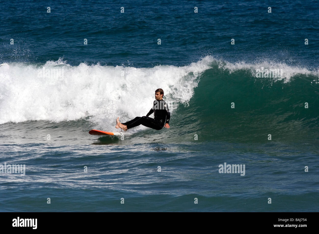 Surfer falling off board Stock Photo - Alamy