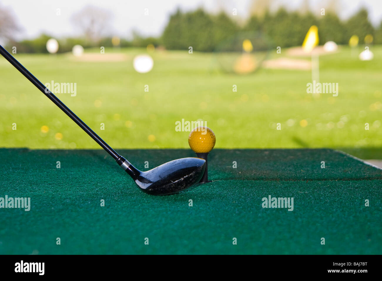 Golf ball ready to be struck on driving range Stock Photo - Alamy