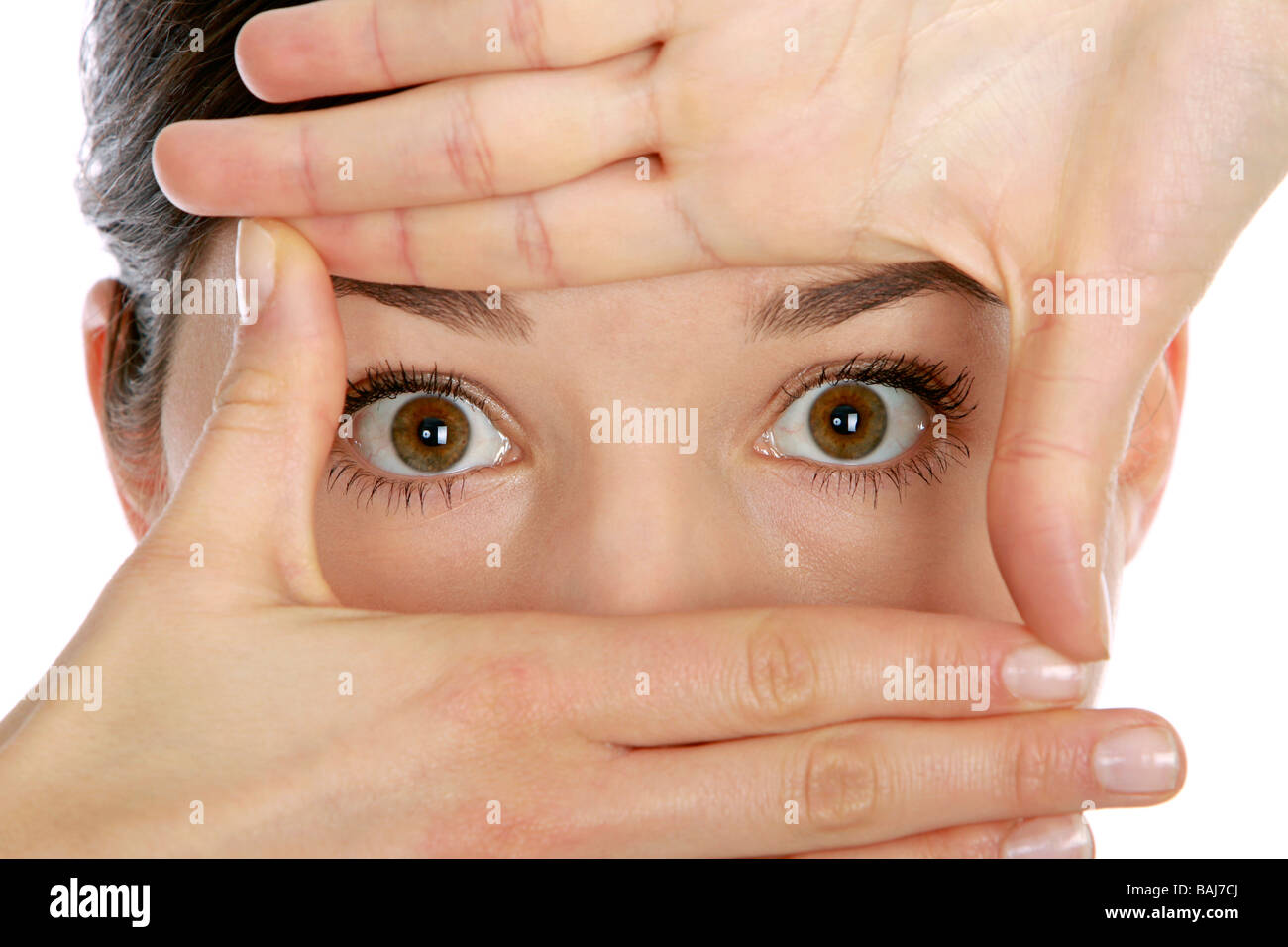 Woman looking through hands Stock Photo - Alamy