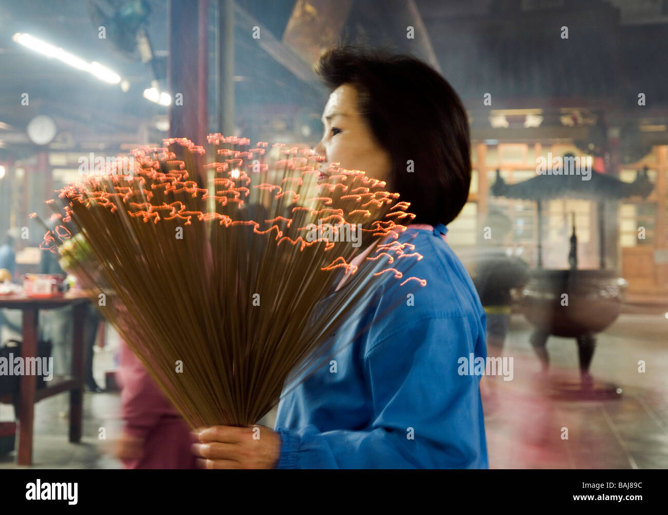 Devotee pray incense sticks hi-res stock photography and images - Alamy