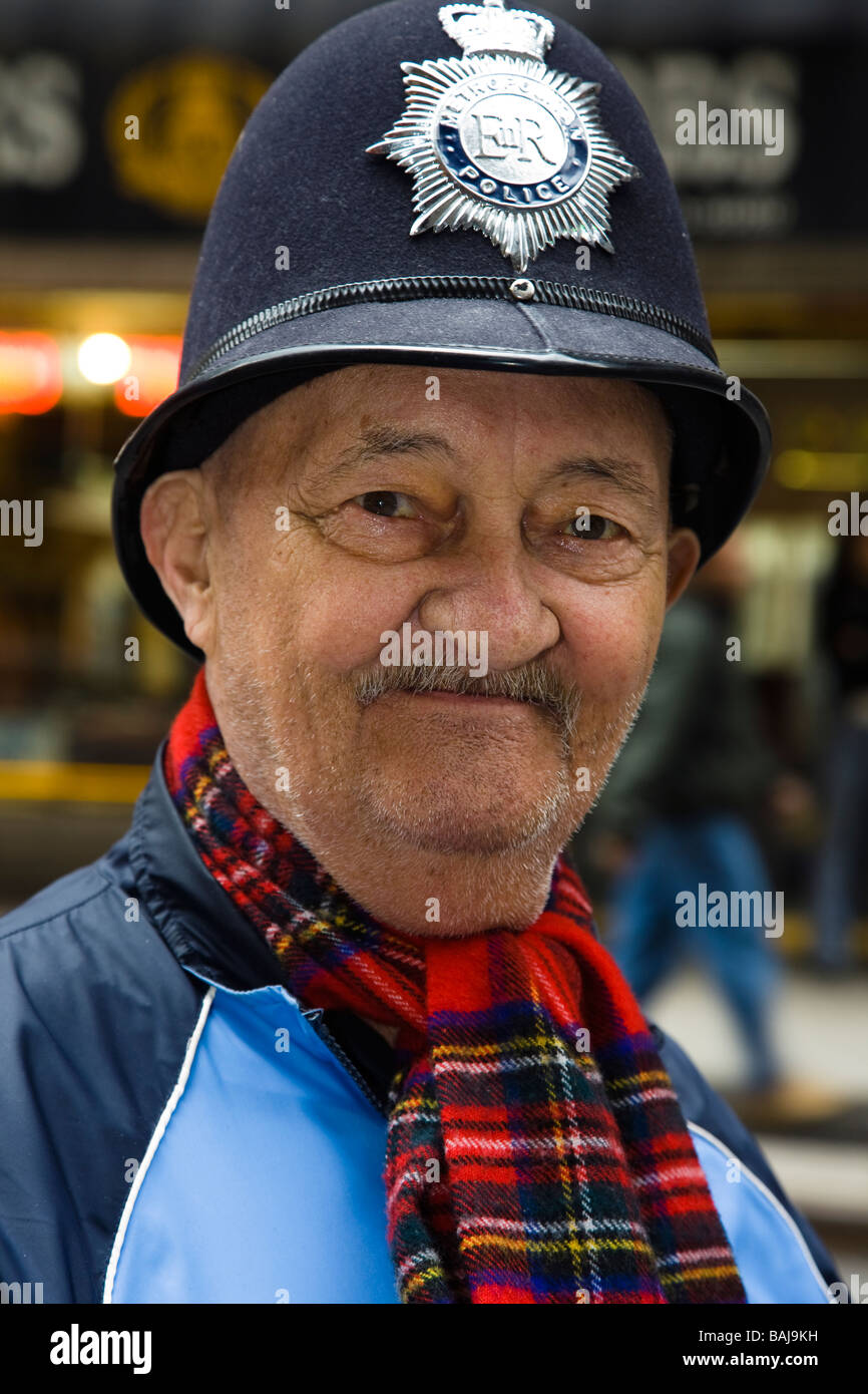 Man dressed with London Policeman's helmet and tartan Scarf at the ...