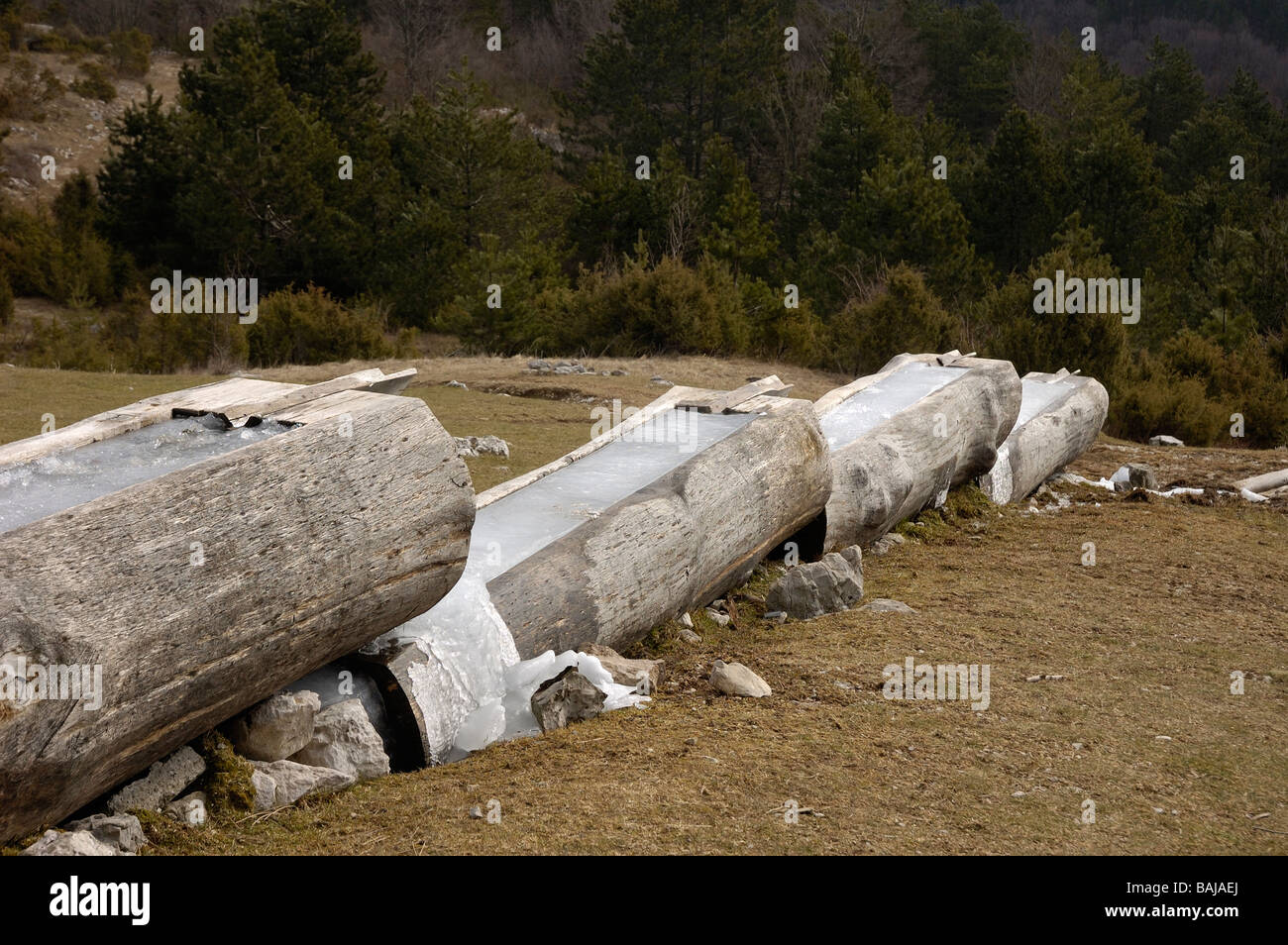 Troughs, watering place for livestock in mountains with frozen water ...