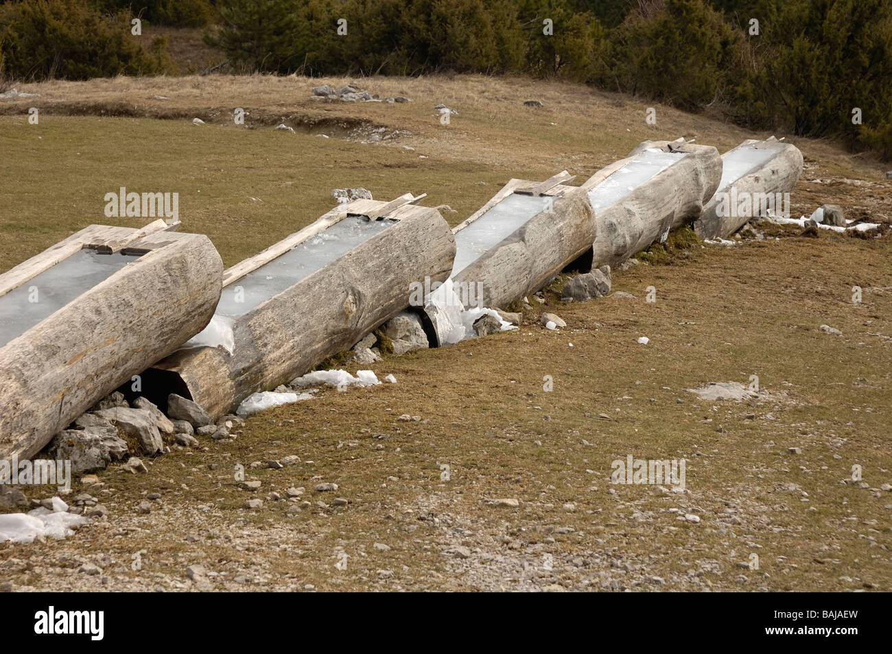 Troughs, watering place for livestock in mountains with frozen water ...