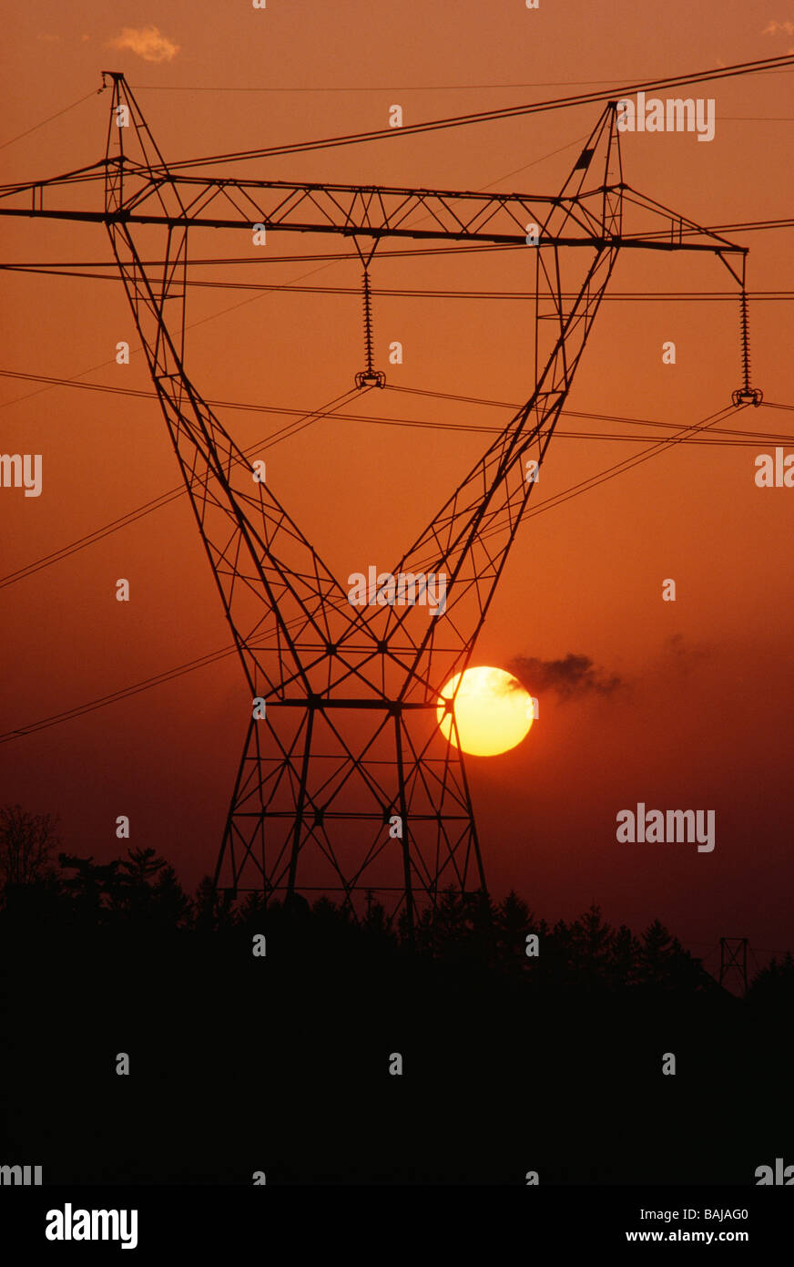 Sunset viewed through electrical transmission power lines and tower ...
