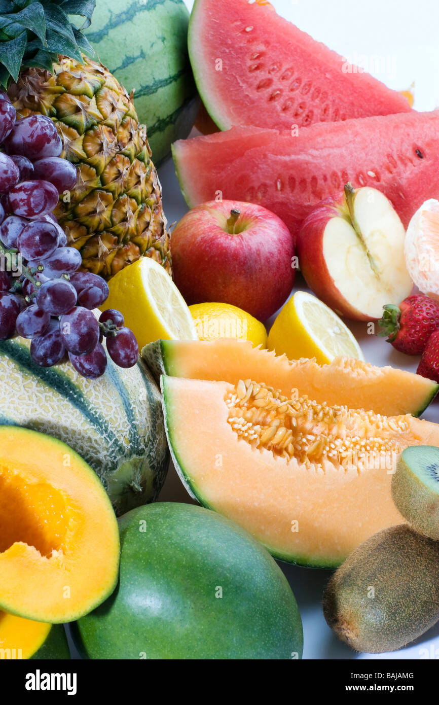 A lot of fresh sliced fruits on white background Stock Photo - Alamy