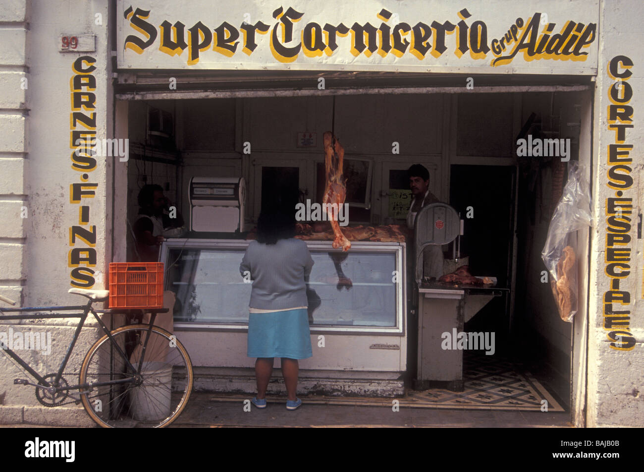 Woman buying meat at a Mexican butcher shop or carniceria in Mexico ...