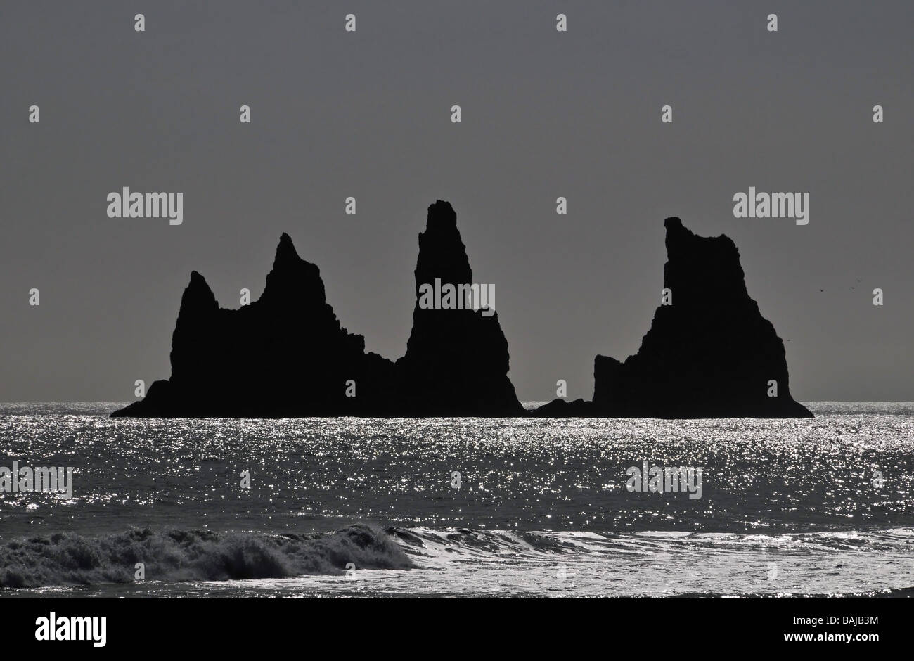 Silhouette landscape shot of the 66m high Reynisdrangur sea stacks ...