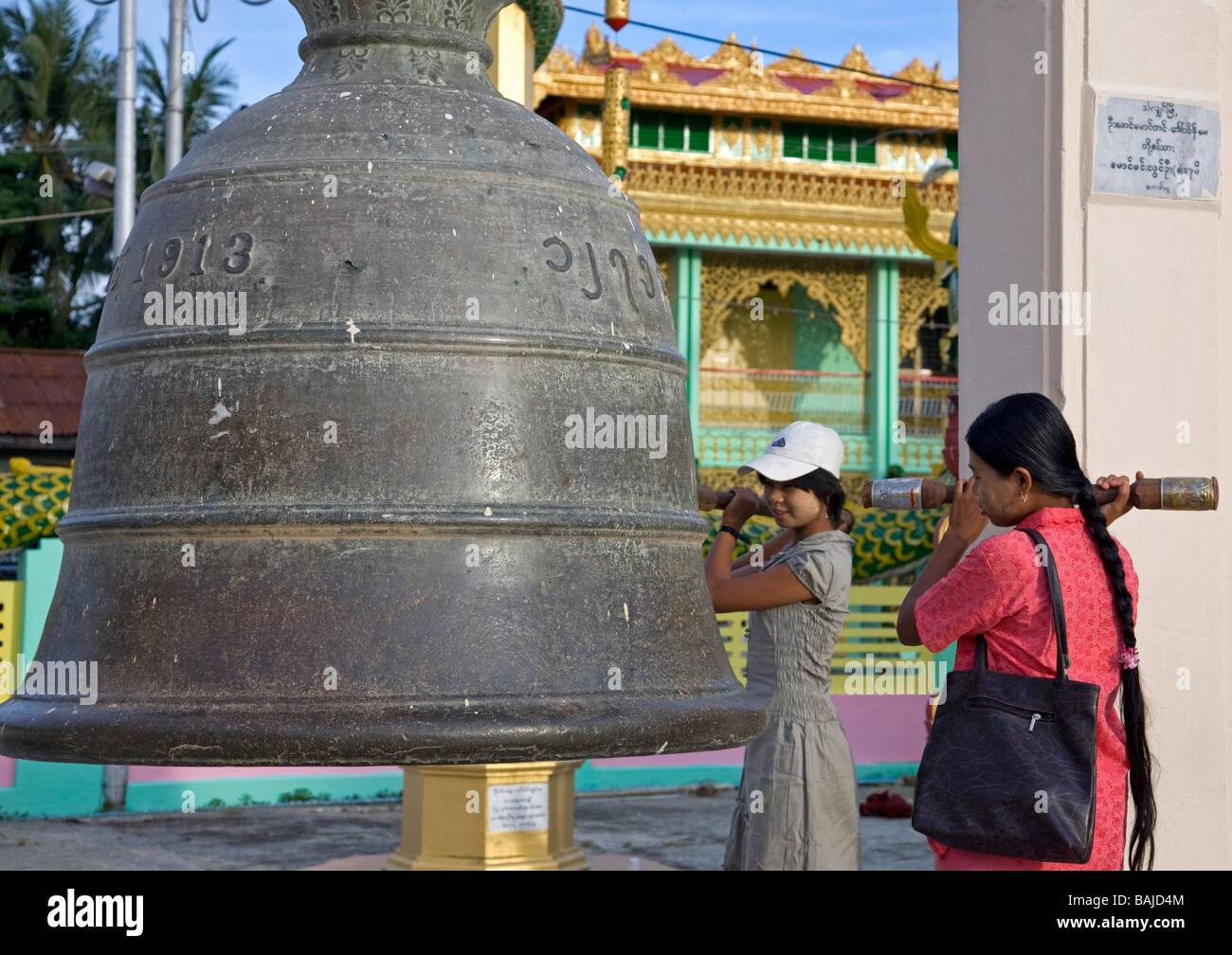 Women praying in front of the Sacred Bell. Botataung Paya. Yangon ...