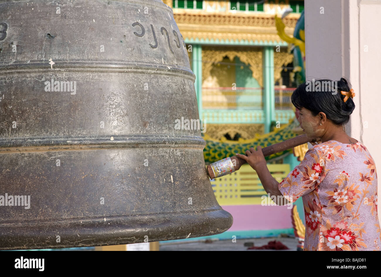 Woman knocking the sacred bell. Botataung Paya. Yangon. Myanmar Stock ...