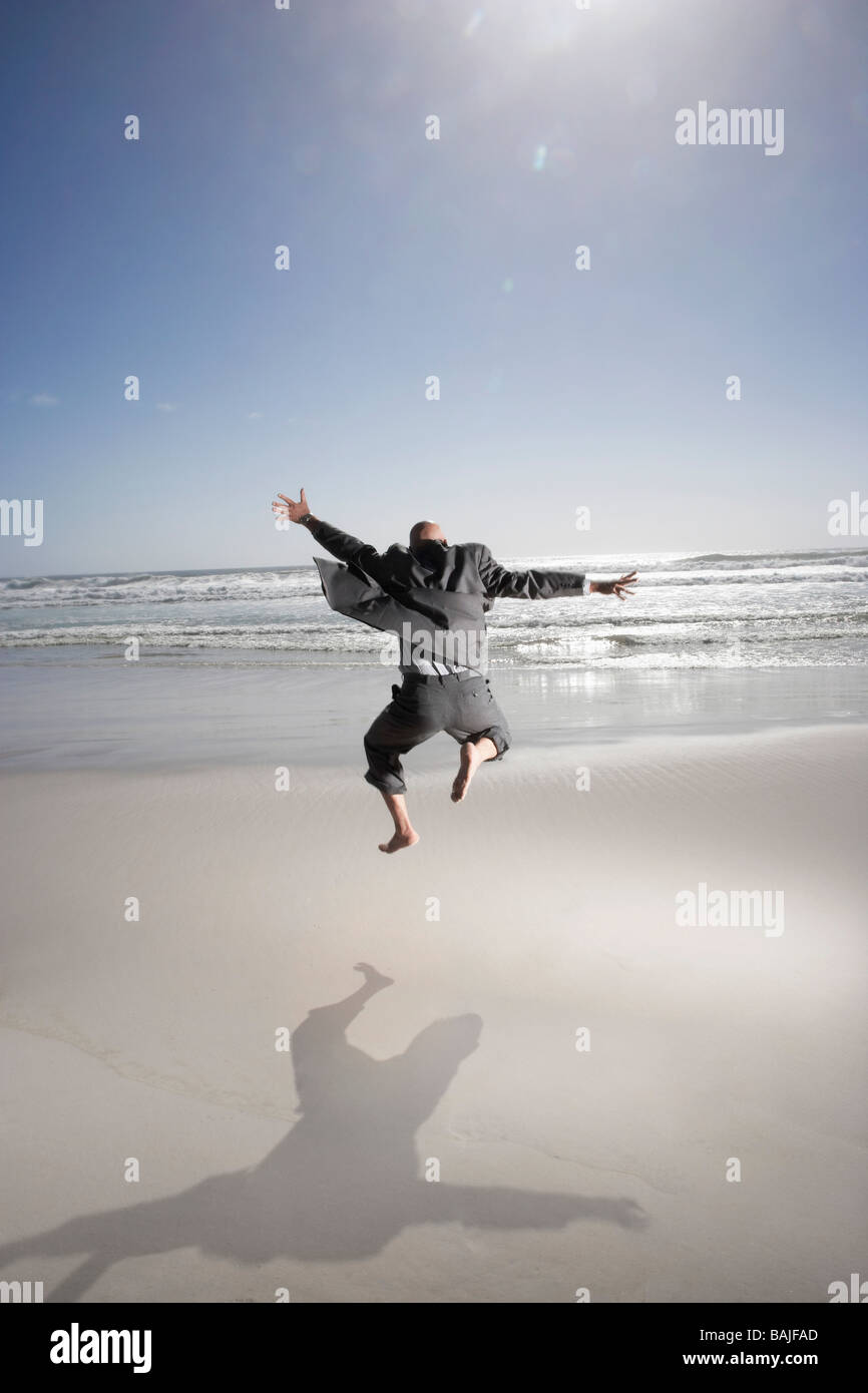 Back man jumping air beach hi-res stock photography and images - Alamy
