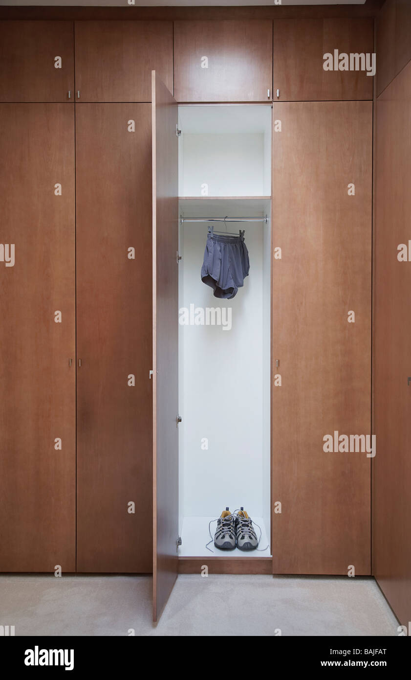 Athletic shoes and running shorts in locker with open door Stock Photo ...