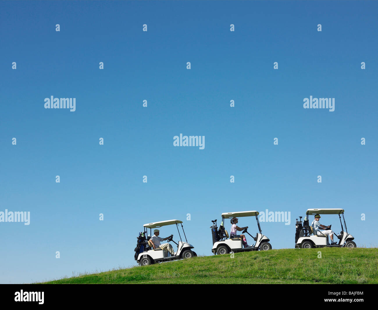Golfers driving carts Stock Photo - Alamy