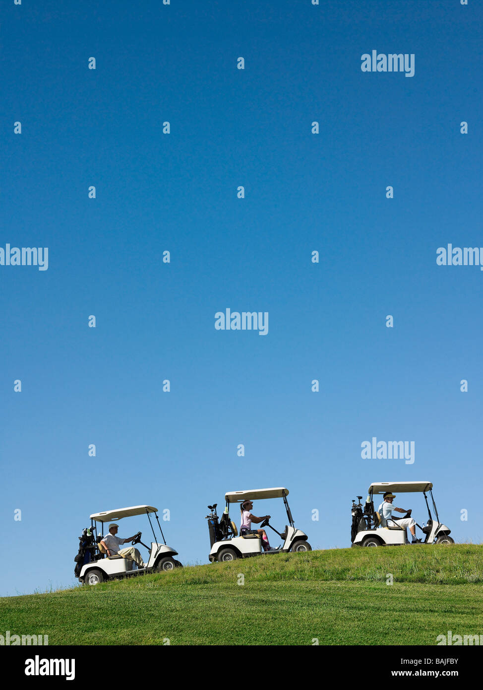 Golfers driving carts Stock Photo - Alamy