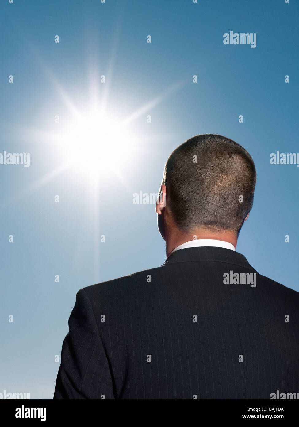 Businessman looking at sun, head and shoulders, back view Stock Photo ...