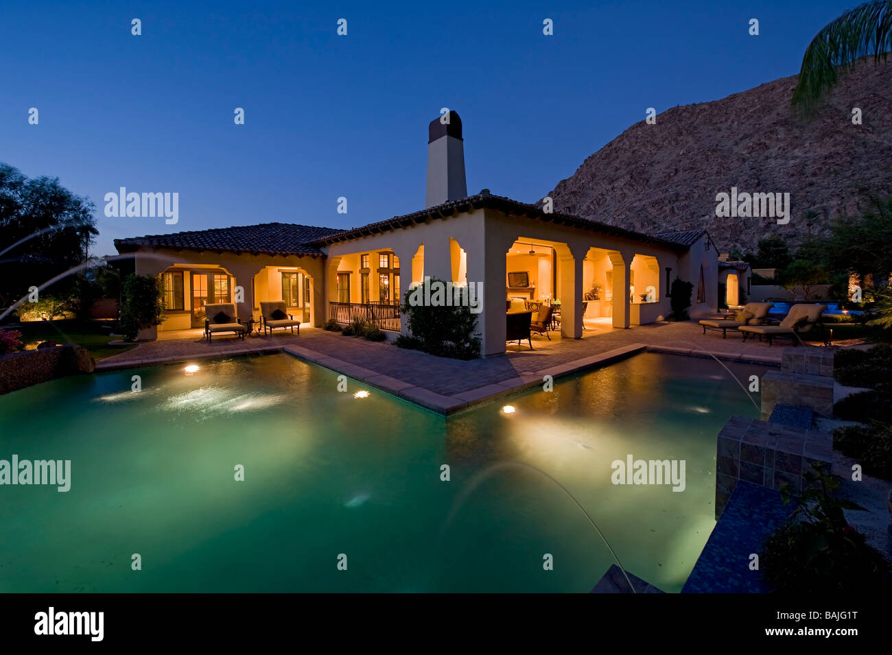 House exterior with swimming pool in backyard at dusk Stock Photo - Alamy