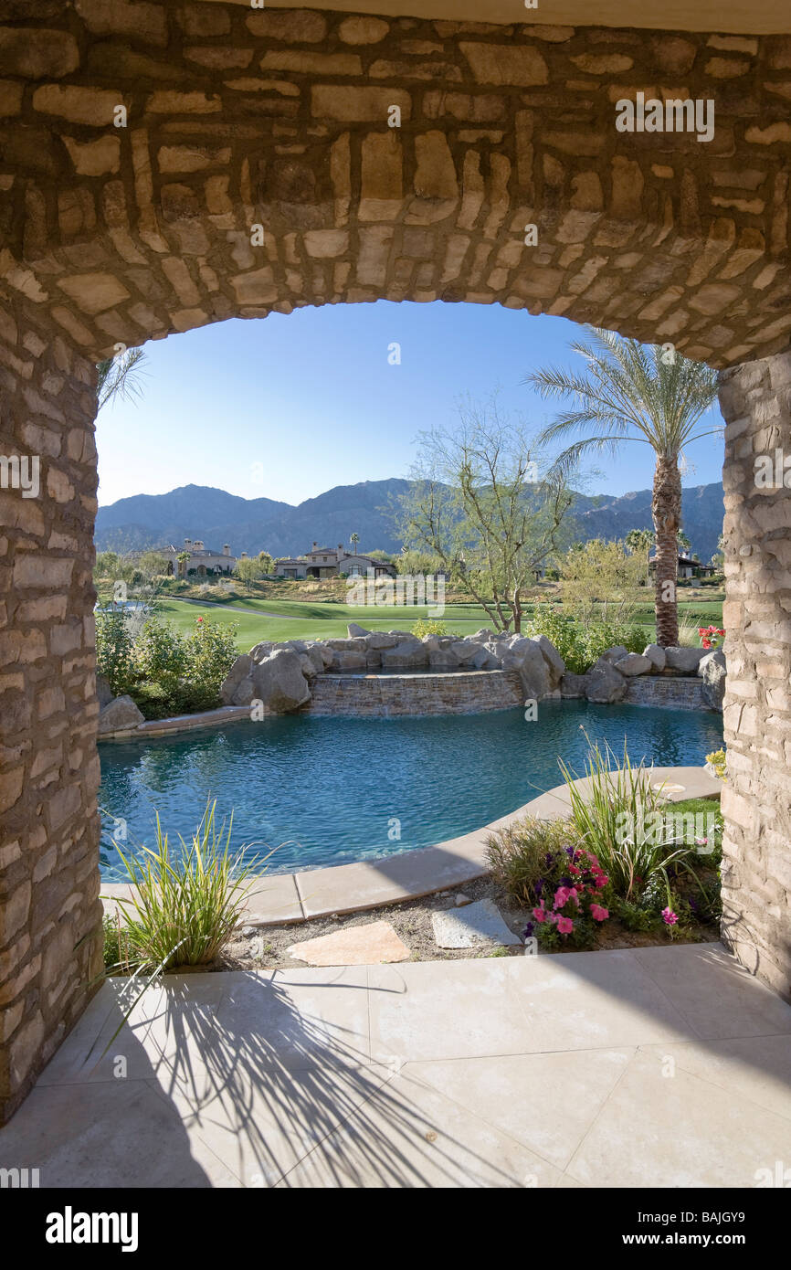 Arch overviewing swimming pool by luxurious residence Stock Photo - Alamy