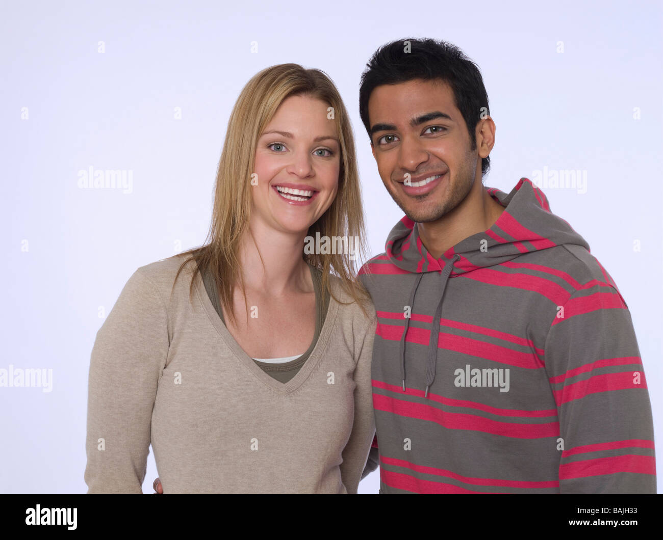 Portrait of young man and woman, studio shot Stock Photo - Alamy