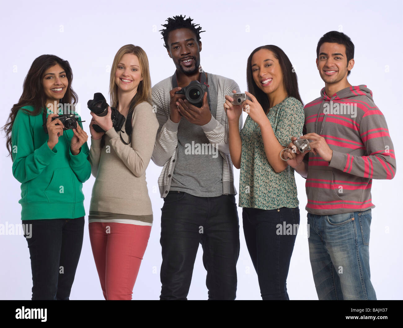 Group of young people holding cameras, studio shot Stock Photo - Alamy