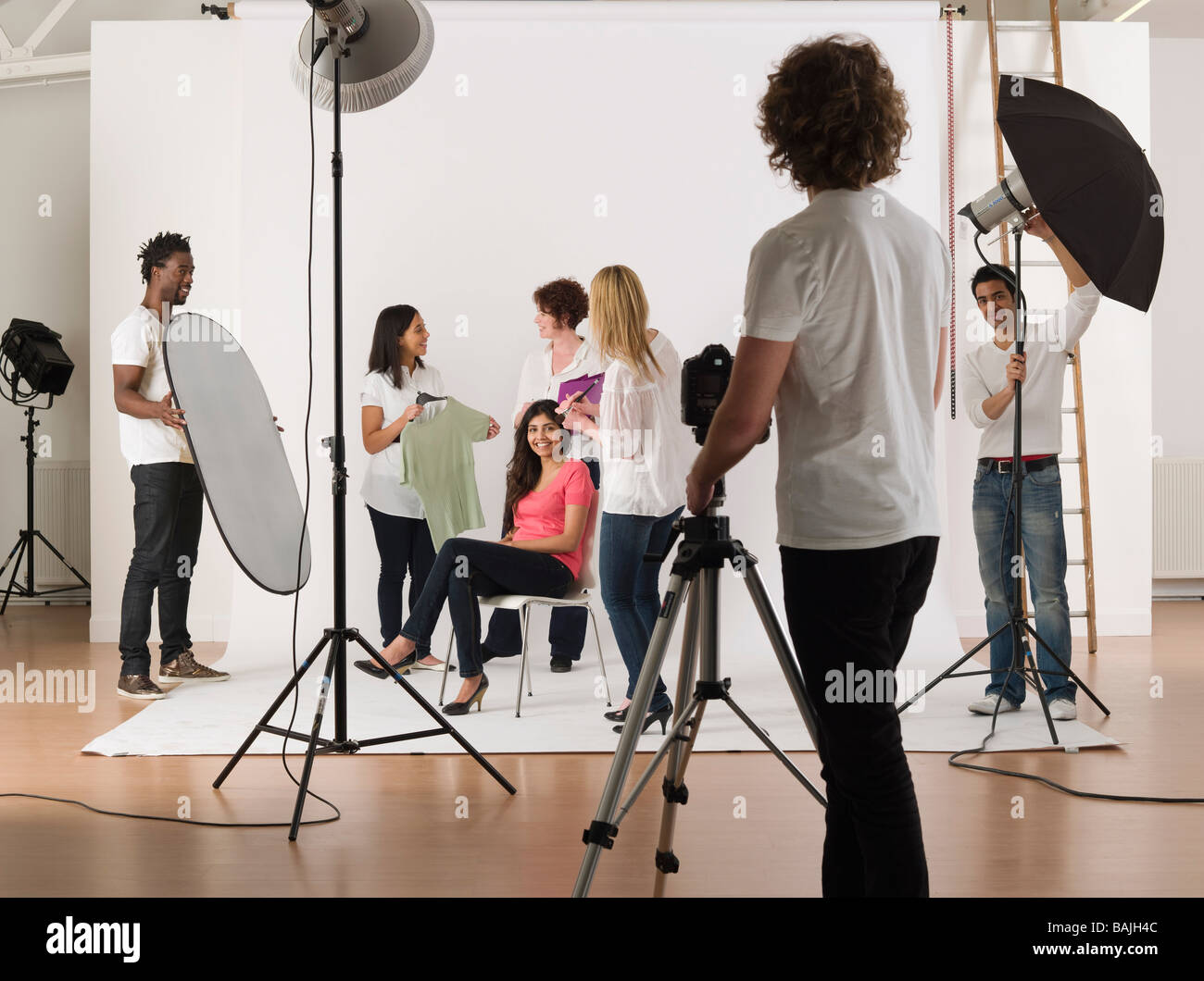 Group of young people in studio during preparing photo session Stock ...