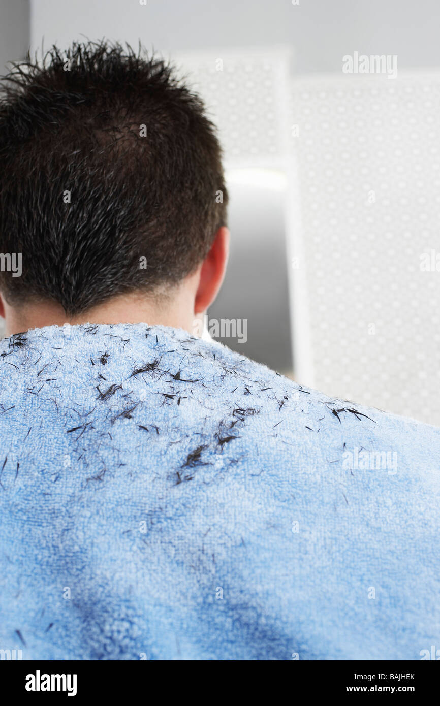 Hair on man's shoulders after haircut at barbershop Stock Photo - Alamy