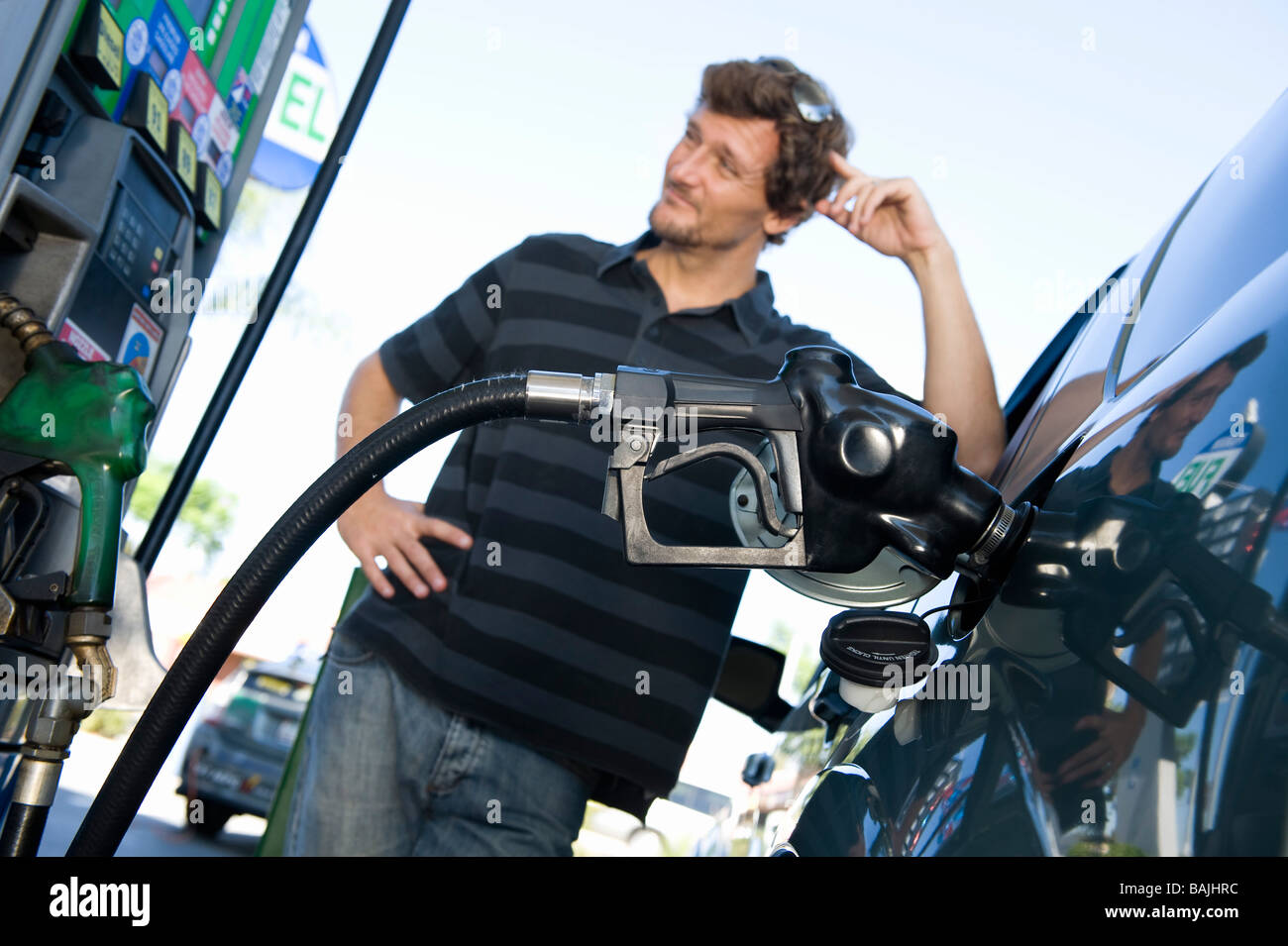 Smiling man refueling car at natural gas station Stock Photo - Alamy