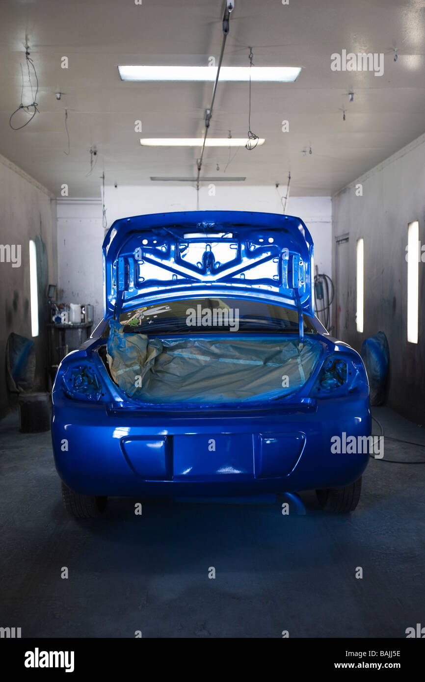 Rear of blue painted car in garage Stock Photo - Alamy
