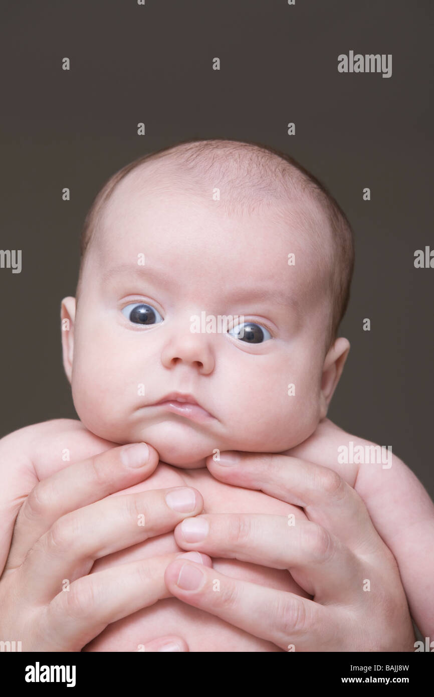Baby girl making face Stock Photo - Alamy
