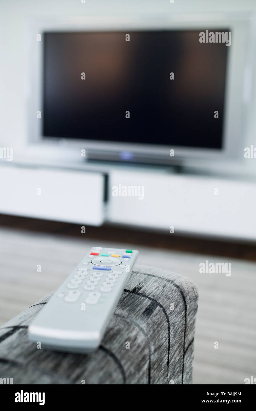 Remote control and television set Stock Photo - Alamy